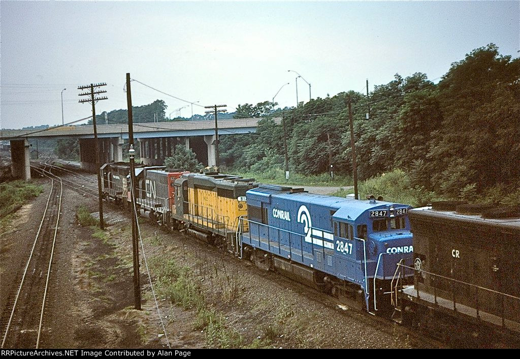 Power moving at the west end of the yard include PC GP40 3123, CN GP38-2 5518, CNW GP30 812, CR ...